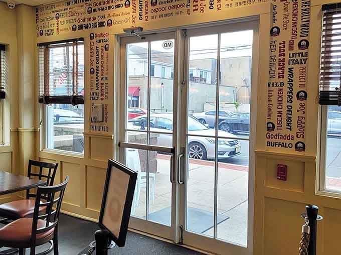 Sunlight streams through glass doors adorned with menu words that read like poetry to anyone who appreciates good food.