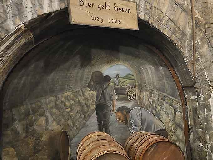 Hand-painted murals in the caves depict brewers at work, their labor preserved in limestone and artistry.