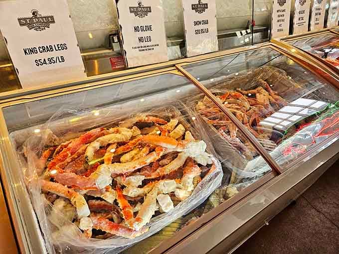 King crab legs sprawled across ice like they're sunbathing at a very expensive beach resort for crustaceans.