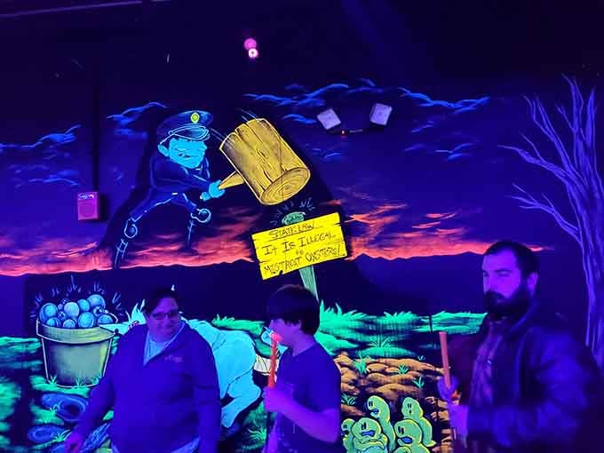 Three generations discovering that blacklight golf is the great equalizer, where grandpa's experience means absolutely nothing.