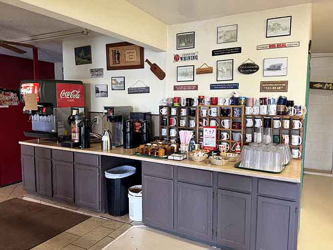 The self-serve coffee station with rows of mugs ready for action, because caffeine waits for no one.