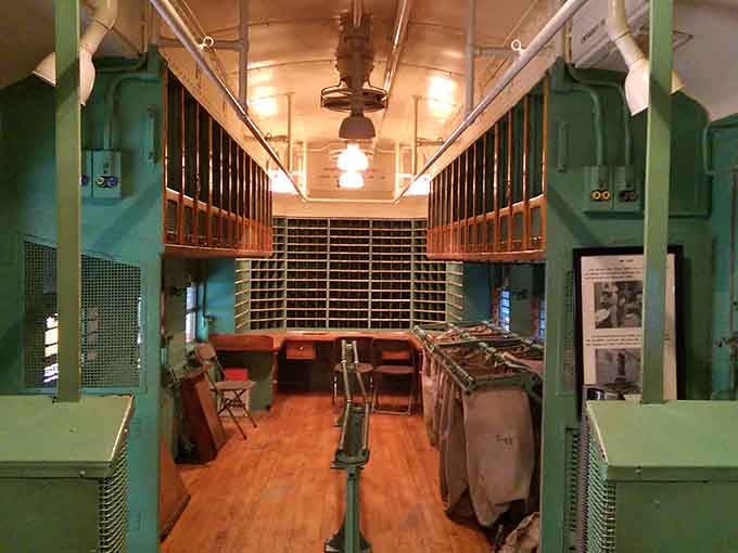 Inside a vintage Railway Post Office car where mail sorting happened while scenery rolled by the windows constantly.