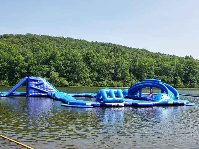 That inflatable water obstacle course floating on the lake makes adulting look way more fun than spreadsheets ever could.