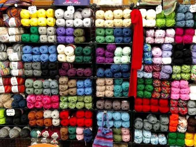 Yarn organized by color like a fiber artist's fever dream come gloriously to life.