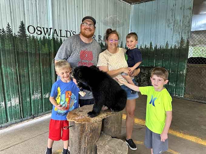 Family photo opportunities include posing with a mounted bear, because regular vacation photos are apparently too boring now.