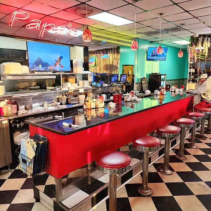 Classic counter seating with red stools invites solo diners to settle in and become part of the family.
