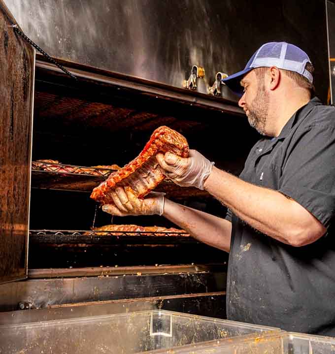 Watching ribs emerge from the smoker is like witnessing edible art being born before your eyes.