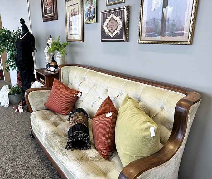 That tufted sofa with wooden arms screams 1970s elegance and could anchor your living room like a conversation piece with cushions.