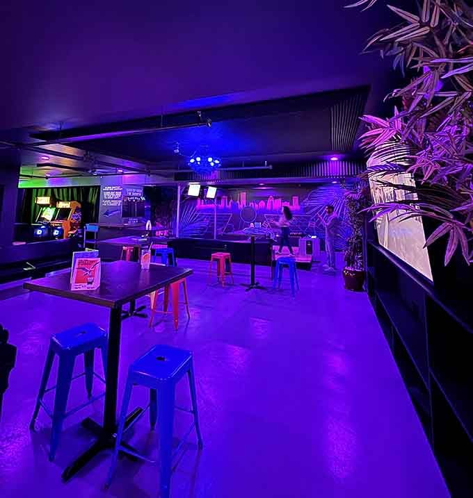Tables and seating bathed in purple light create the perfect spot to strategize your next frame or just relax.