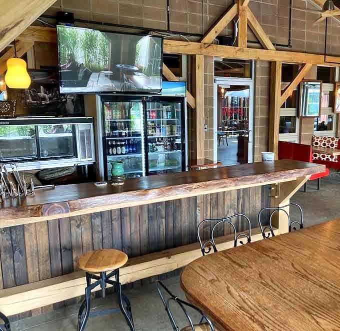 The welcoming bar area features exposed beams and refrigerated beverages ready for thirsty British food enthusiasts.