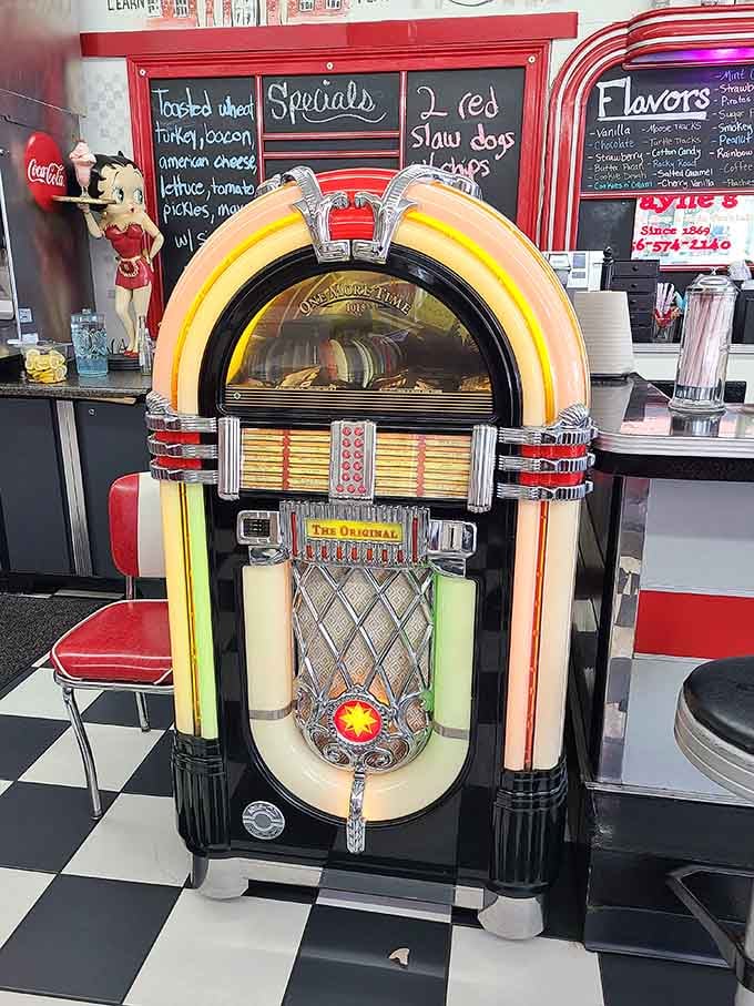 The jukebox stands ready to soundtrack your meal with tunes from when music told stories people actually remembered.