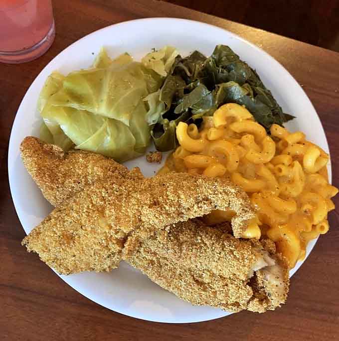 Fried catfish with mac and cheese, greens, and cabbage is basically the Mount Rushmore of Southern comfort food.