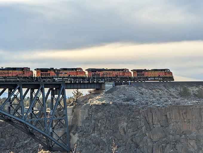 Freight trains rumbling across the 1911 railroad bridge create a scene straight from a Western movie.