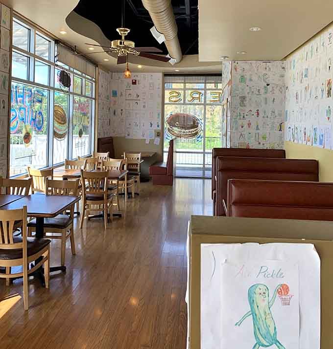 Bright, welcoming dining space covered in pickle-themed artwork that'll make you smile before your food even arrives.