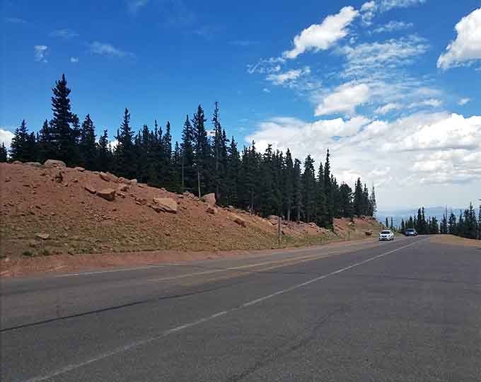 Dense evergreens frame the highway as it begins its ascent through Colorado's spectacular high country.