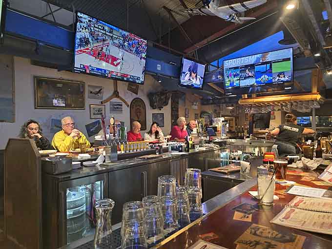 The bar where aviation enthusiasts and hungry locals unite under TVs and model planes, creating the perfect neighborhood gathering spot.