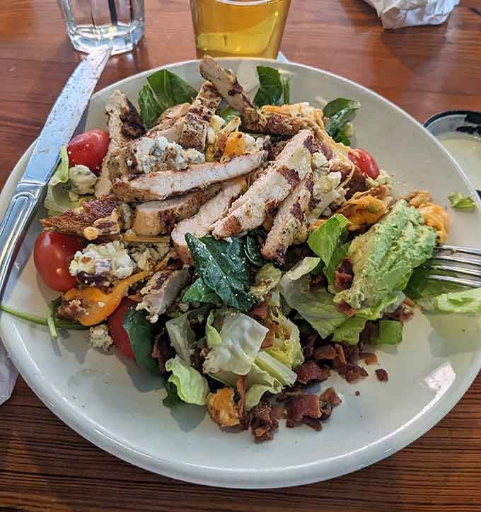 Grilled chicken atop fresh greens with bacon and blue cheese crumbles offers a lighter option that doesn't skimp on flavor.