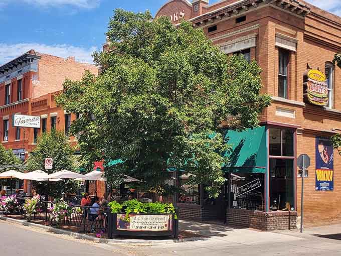 Tree-lined streets and outdoor dining create the kind of neighborhood atmosphere where people actually want to spend time.