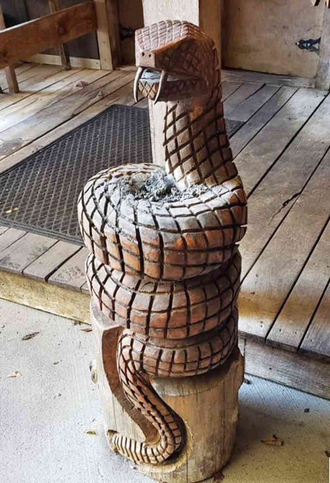 This hand-carved rattlesnake sculpture coiled on a wooden post reminds visitors they're dining somewhere wild, wonderful, and wonderfully weird.