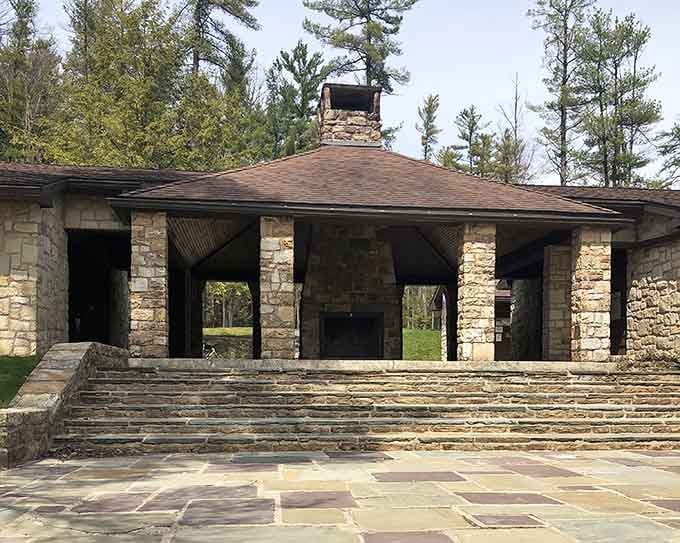 Stone and timber pavilion architecture blends seamlessly with surroundings, providing gathering spaces for reunions where everyone actually gets along.