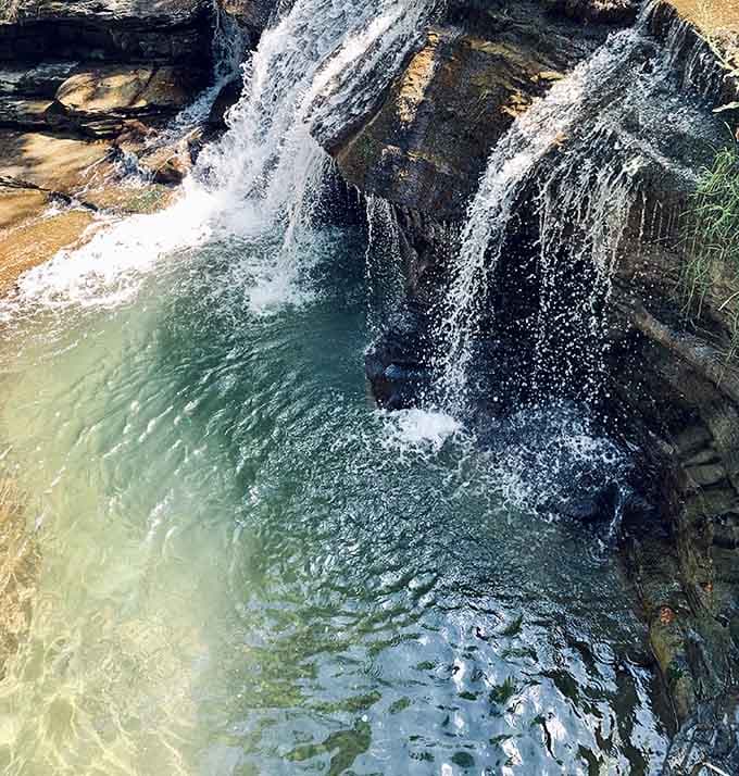 Crystal-clear waters pool beneath small cascades, creating swimming spots that look straight from a travel magazine.