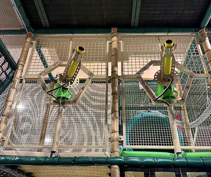 Those bamboo-style cannons launch foam balls across the play structure, turning physics into pure childhood joy and laughter.