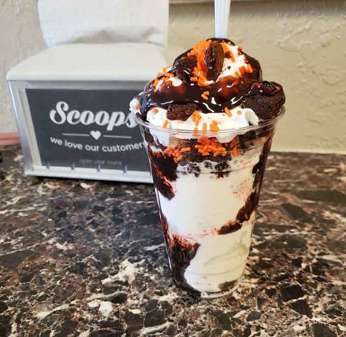 This brownie sundae towers with the kind of architectural ambition that would make engineers nervous but dessert lovers ecstatic.