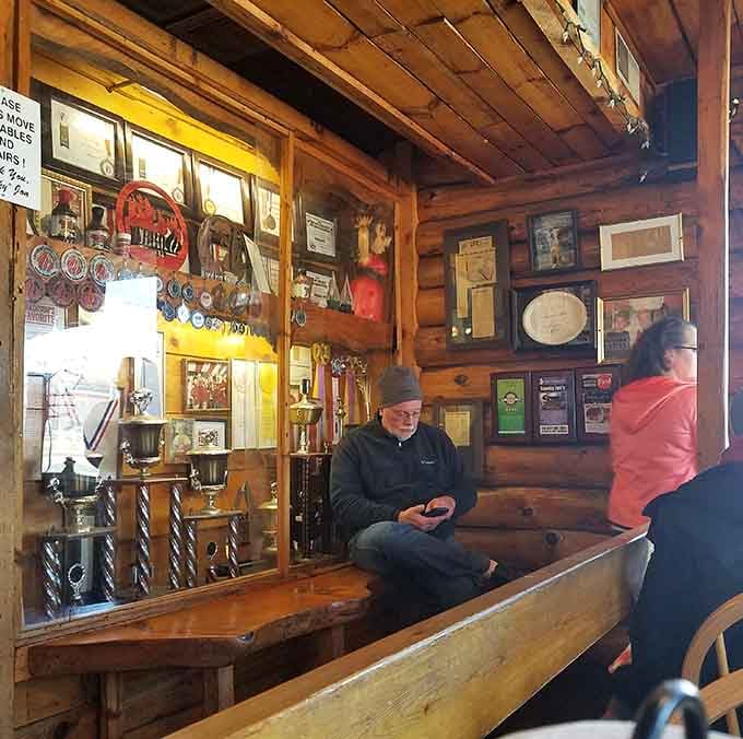 Trophies and memorabilia create a waiting area that doubles as a museum of barbecue excellence and community appreciation.