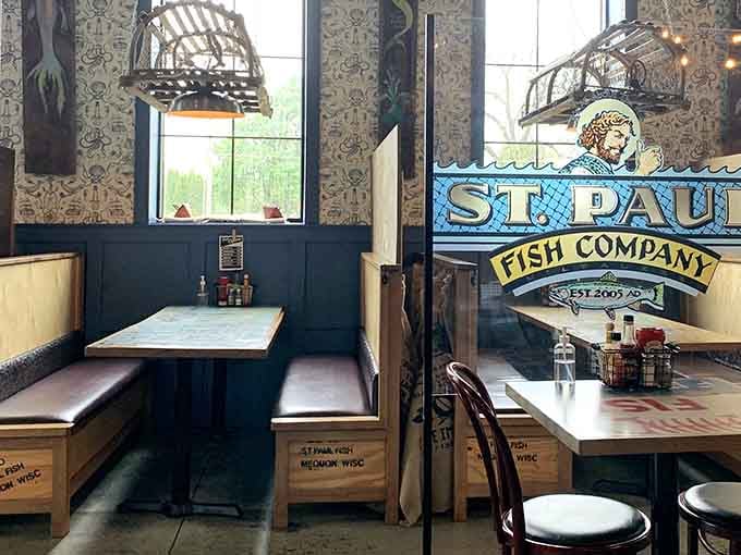 Cozy booths with ocean-themed tables invite lingering conversations over plates piled high with delicious seafood treasures.