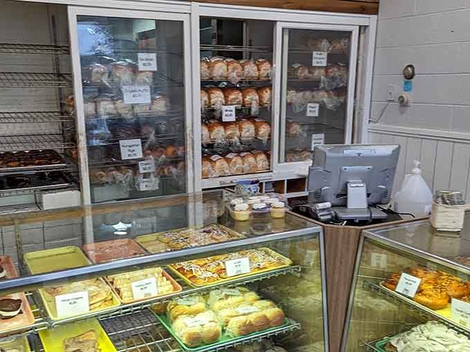 The register area where transactions happen but friendships begin, one bakery box at a time, always smiling.