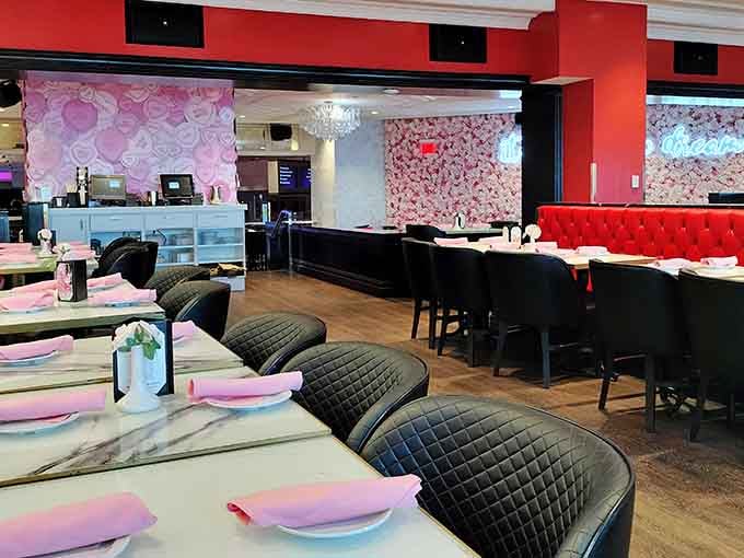 Pink floral walls meet quilted seating, creating an aesthetic that's part diner, part dollhouse, entirely committed to the bit.