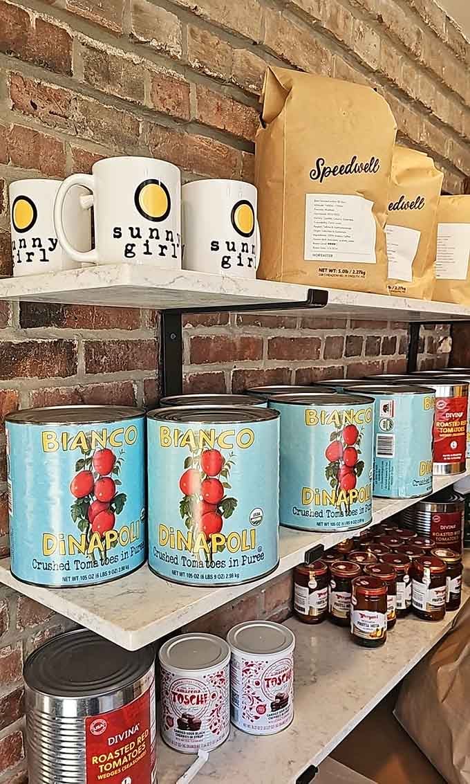 Sunny Girl mugs and pantry staples lining the shelves—because sometimes you want to take the good vibes home.