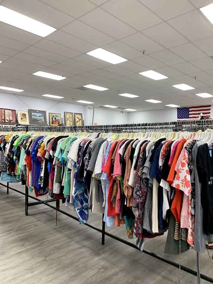 The American flag watches over this rainbow of garments, a patriotic reminder that bargains are truly American.