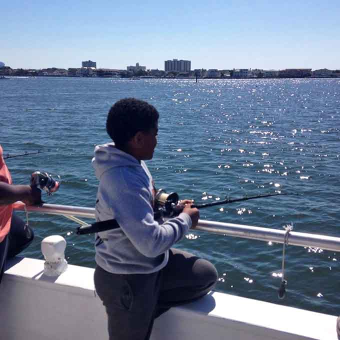 Young anglers discovering that fishing from a yacht is infinitely cooler than fishing from a dock.