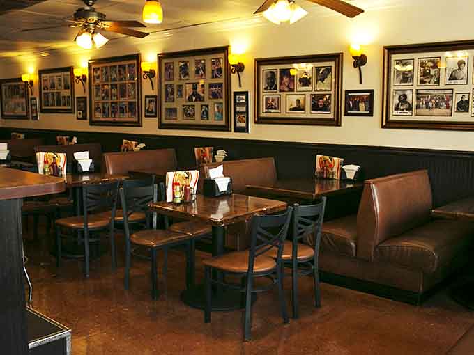 Framed photographs line walls painted sunshine yellow, telling stories of community while ceiling fans spin overhead keeping things cool.