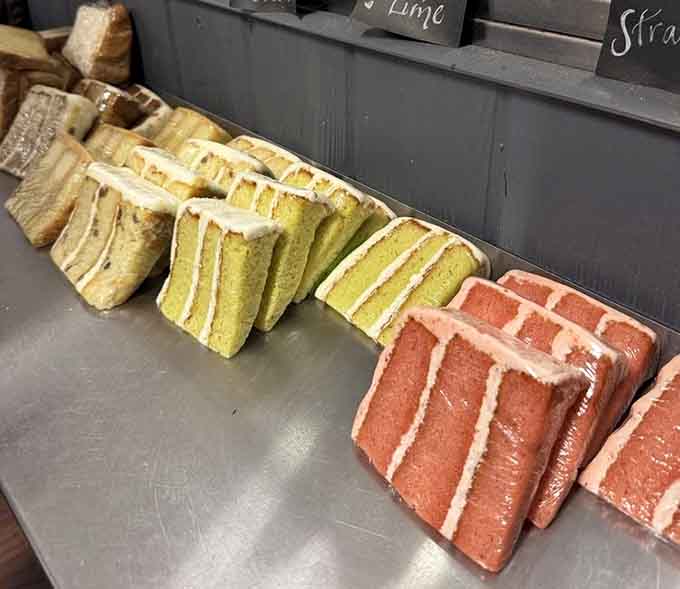 Cake slices lined up like colorful soldiers ready to wage delicious war on your willpower and win decisively.