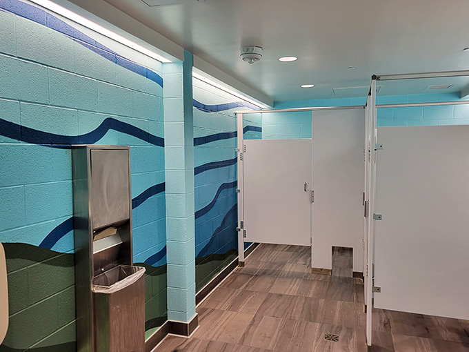 Clean, modern facilities with wave-themed walls prove that even the practical spaces get thoughtful design attention.