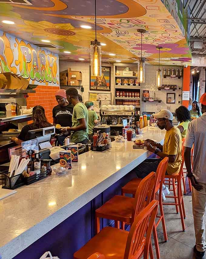 The counter seating offers front-row views of the kitchen action while colorful artwork keeps things delightfully entertaining overhead.