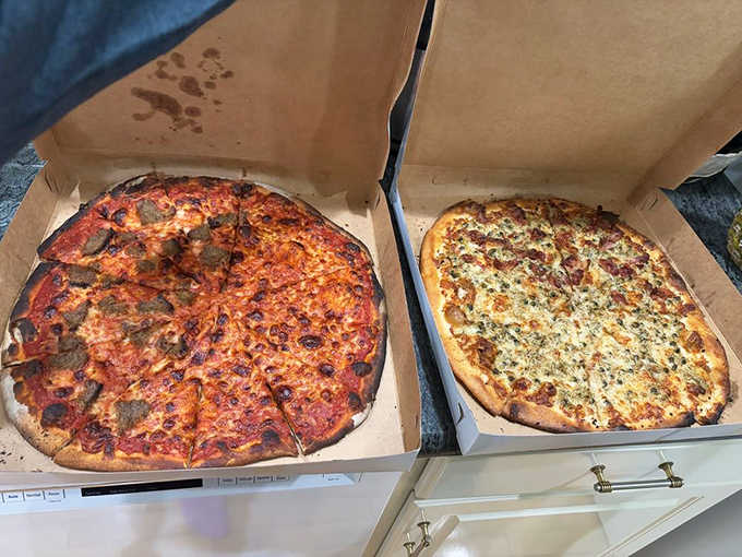 Two boxes of happiness ready to go, proving that sometimes the best decision is ordering more than one pie for the road.