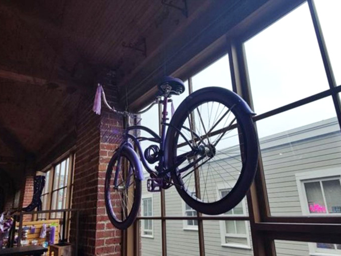 That suspended bicycle overhead adds urban edge to the space, like something from a hip coffee shop.