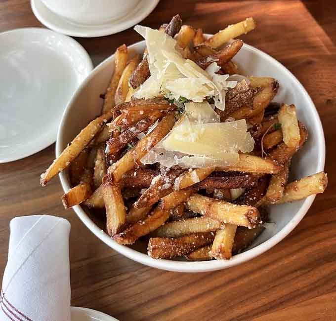Parmesan garlic fries topped with shaved cheese, proving that some side dishes deserve to be the main event.