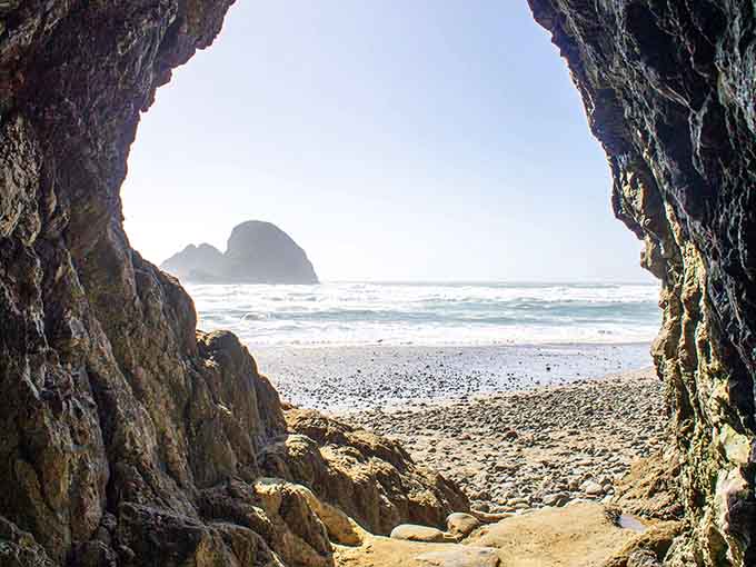 Tunnel Beach's natural archway frames Haystack Rock like a postcard that somehow became real life.