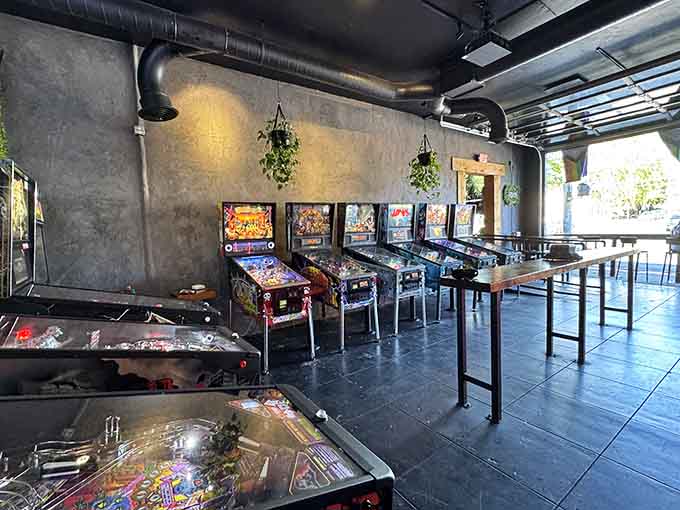 Classic pinball machines line the wall because nothing pairs better with pizza and beer than nostalgic arcade entertainment from childhood.