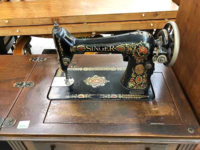 A vintage Singer sewing machine that's seen more action than most modern gadgets, still ready for duty.