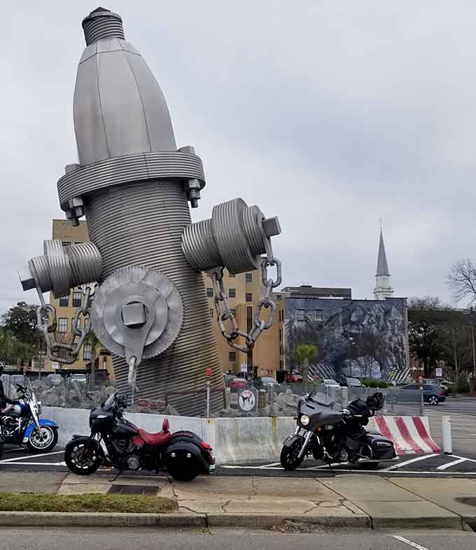 That giant fire hydrant sculpture nearby is like the mural's quirky cousin who also demands attention.