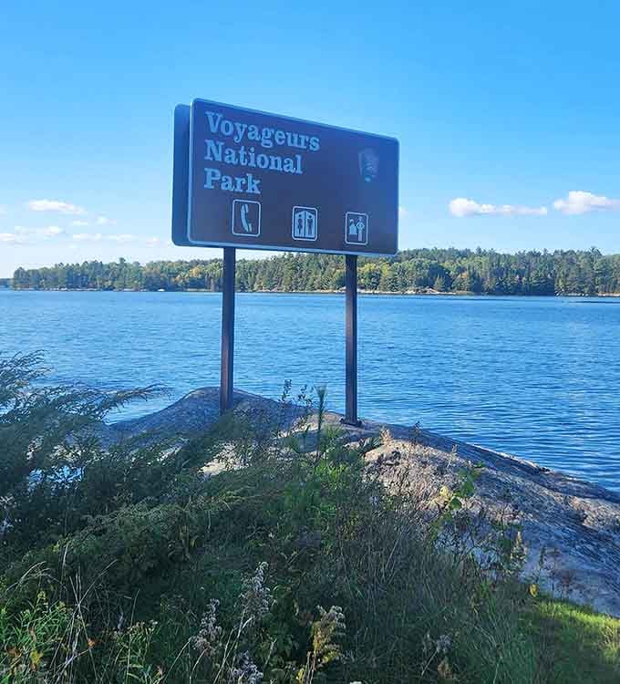 The official welcome sign stands proudly by the water, because even wilderness needs proper introductions and good manners.