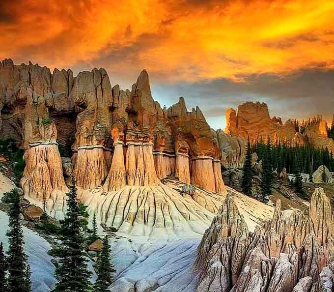 Sunset transforms the formations into glowing towers of fire, creating a spectacle that cameras struggle to capture adequately.