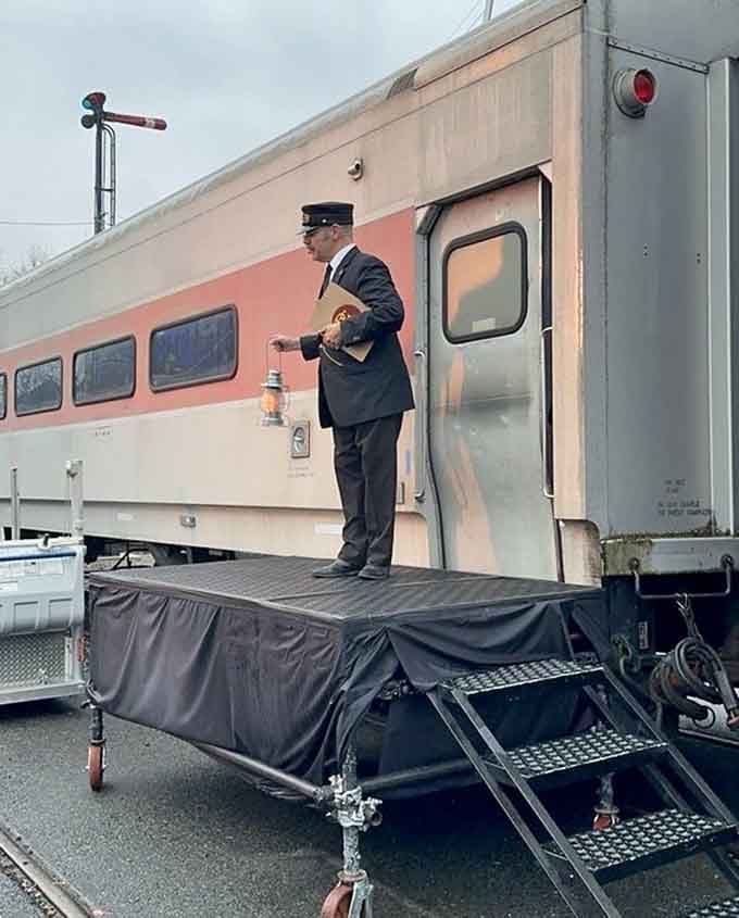 The conductor stands ready to welcome passengers aboard, keeping traditions alive one vintage journey at a time.