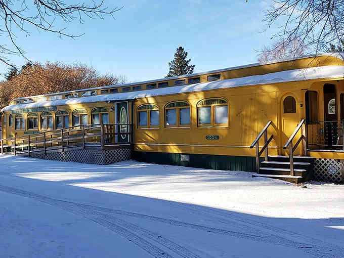 Winter transforms the train car into a cozy snow-covered sanctuary that looks like it belongs on a postcard.
