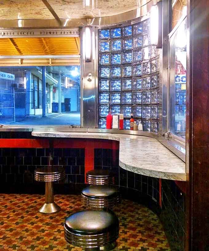 Glass block curves and chrome stools create a retro atmosphere that makes you want to order everything twice.